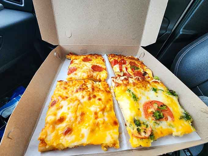 Four varieties of pizza in one box means nobody has to compromise, which is basically the definition of happiness.