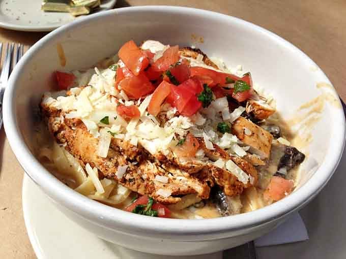 Blackened chicken pasta gets topped with fresh tomatoes and cheese, turning simple fettuccine into something worth writing home about.