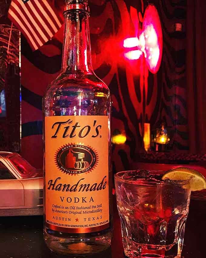 Tito's vodka takes center stage in this atmospheric shot, ready to fuel your end-of-the-world party plans with style.