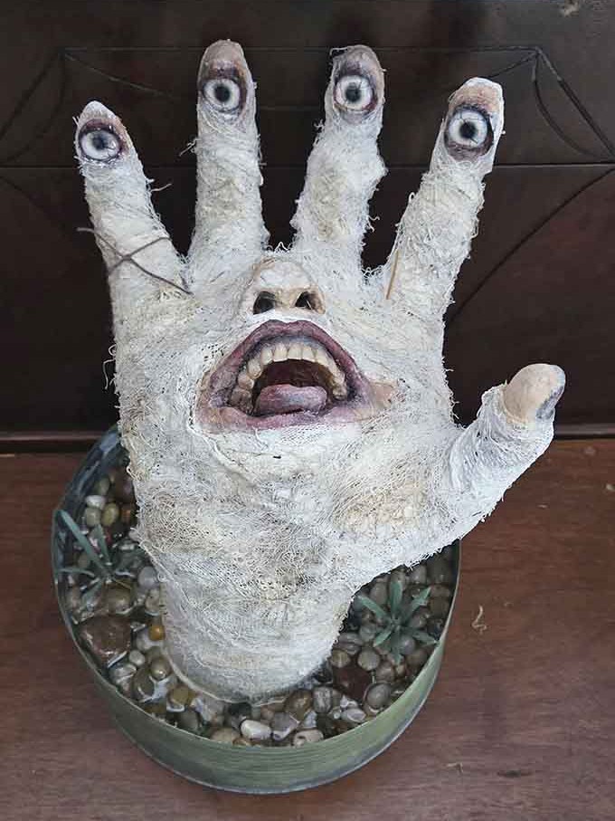 When your succulent planter is a hand with eyeball fingers, you've officially transcended traditional home decor.