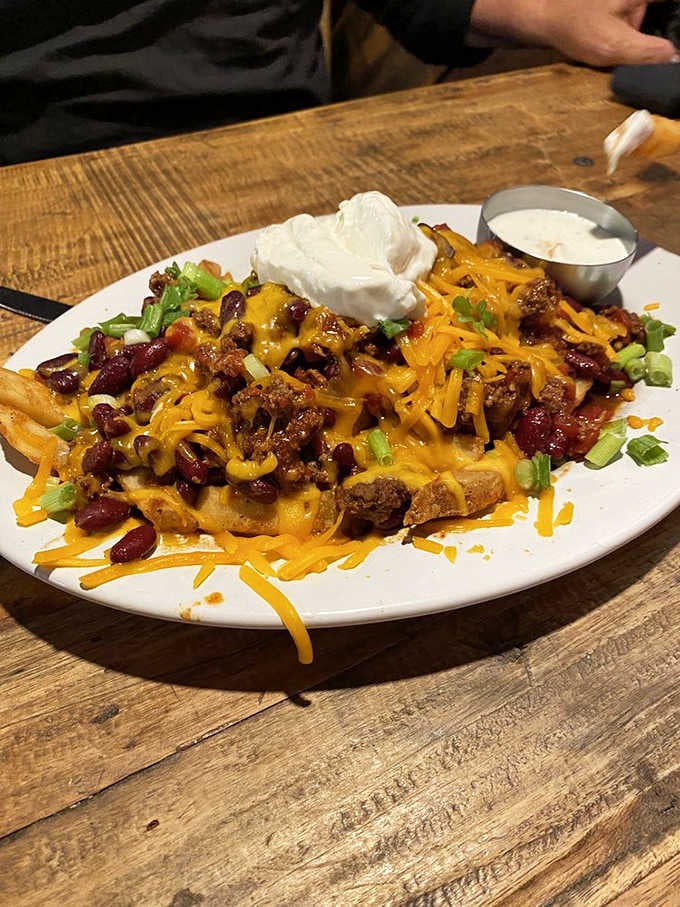 Chili cheese fries topped with ground beef, beans, and sour cream&mdash;because sometimes restraint is overrated and delicious is everything.