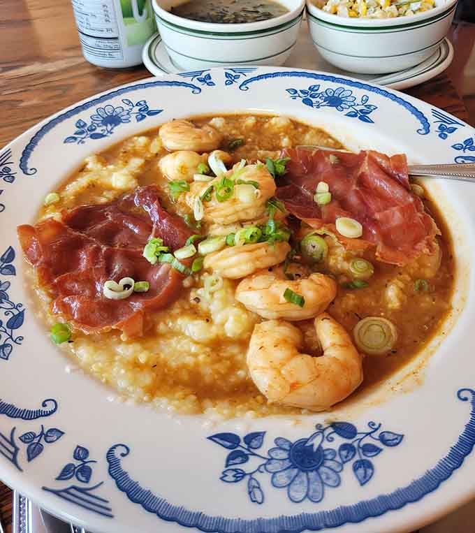 Shrimp and grits topped with country ham&mdash;creamy, savory comfort that'll make you reconsider everything you know.