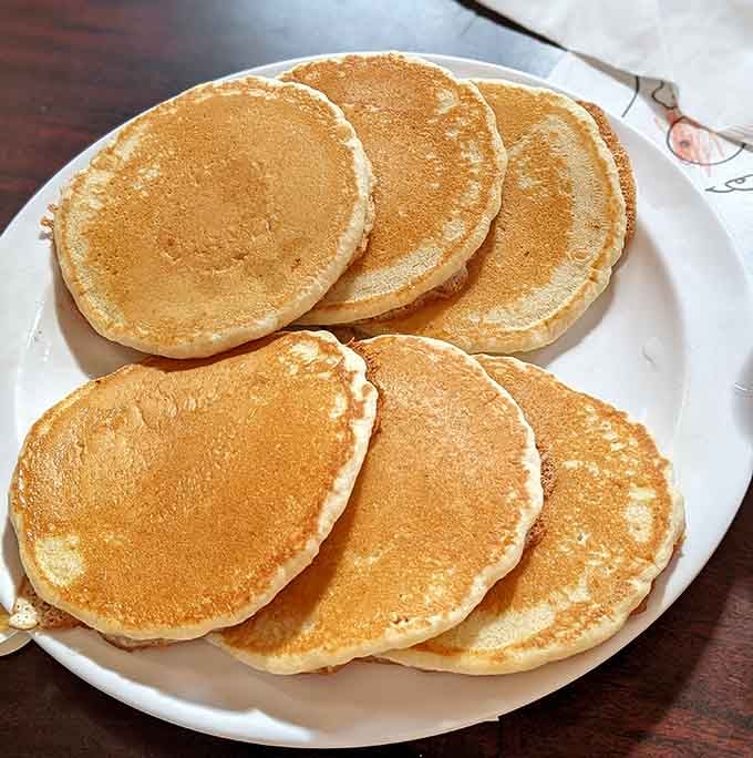 Six perfect pancakes arranged like edible flying saucers, ready to transport you straight to breakfast heaven.