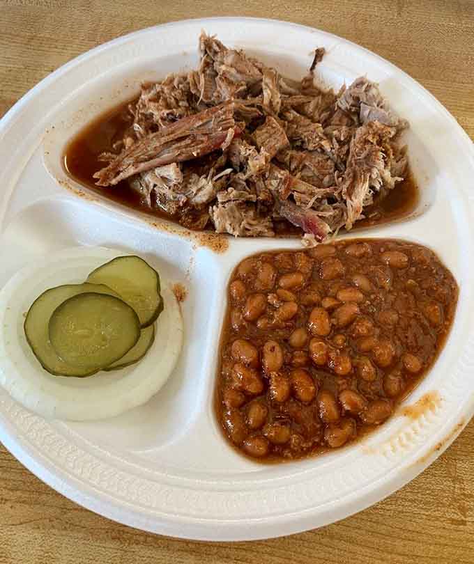 Pulled pork so tender it surrenders before you even pick up your fork, with beans as backup.