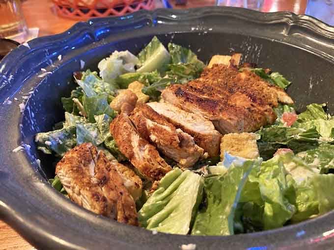Caesar salad gets elevated with perfectly seasoned grilled chicken, making vegetables feel like a celebration rather than obligation.