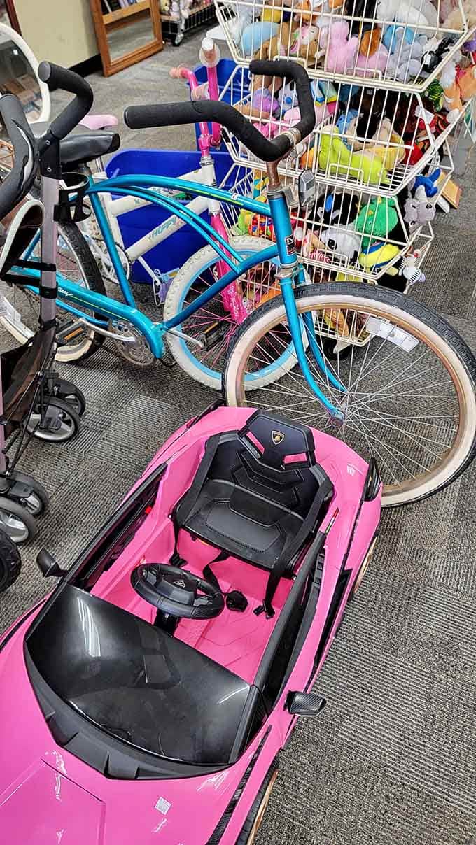 A pink electric car and turquoise bicycle prove that kids' items here are barely used and ready for adventure.
