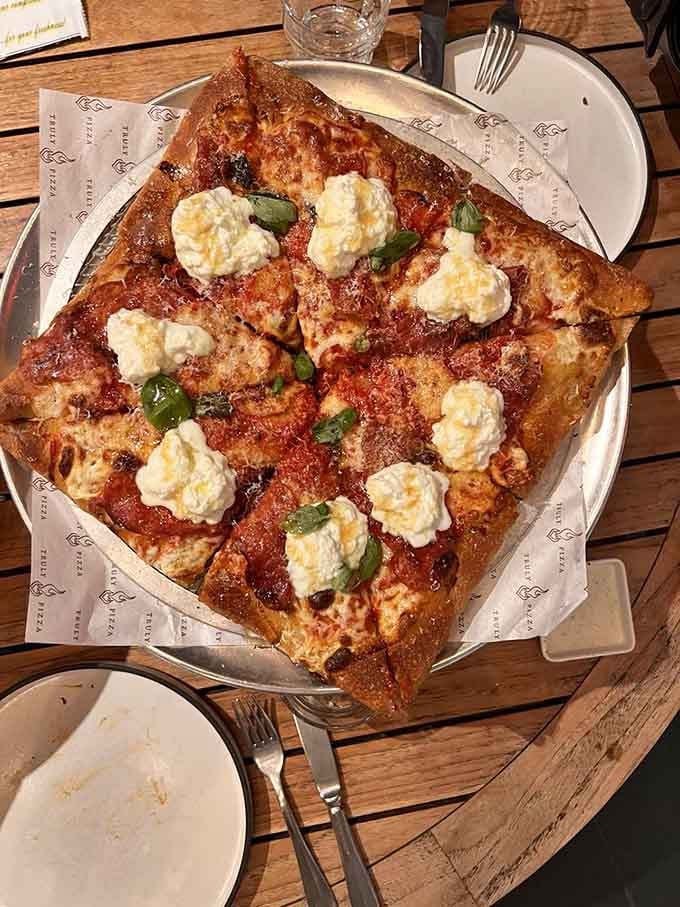 Golden crust with charred edges and melted cheese proves that sometimes the simplest pizzas reveal the most about a pizzeria's skill.