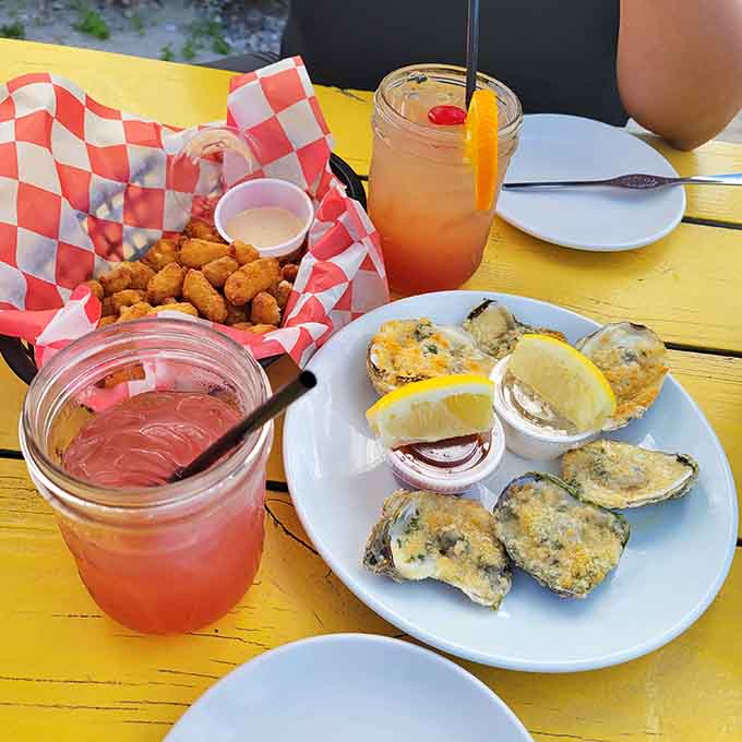 Baked oysters and colorful cocktails on a yellow table scream vacation mode, even if you're ten minutes from home.
