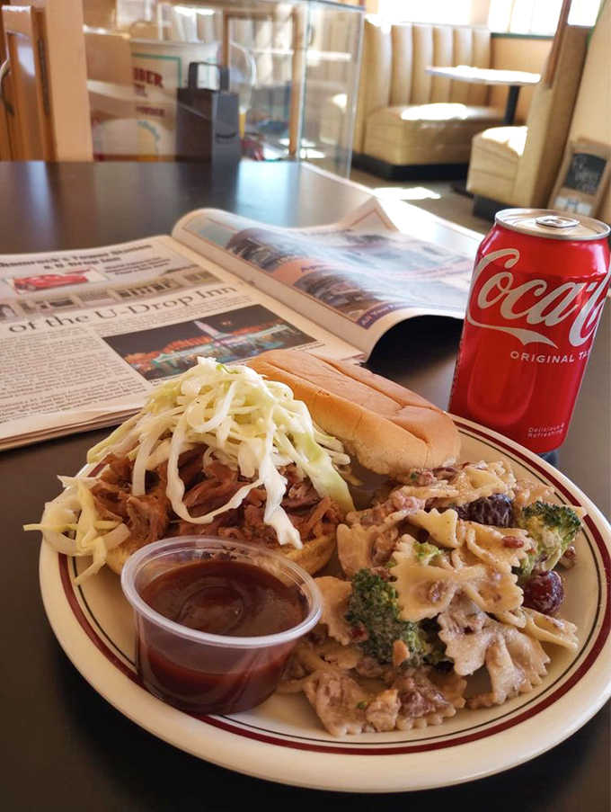 Pulled pork piled high with coleslaw on a toasty bun, served alongside pasta salad that knows its purpose.