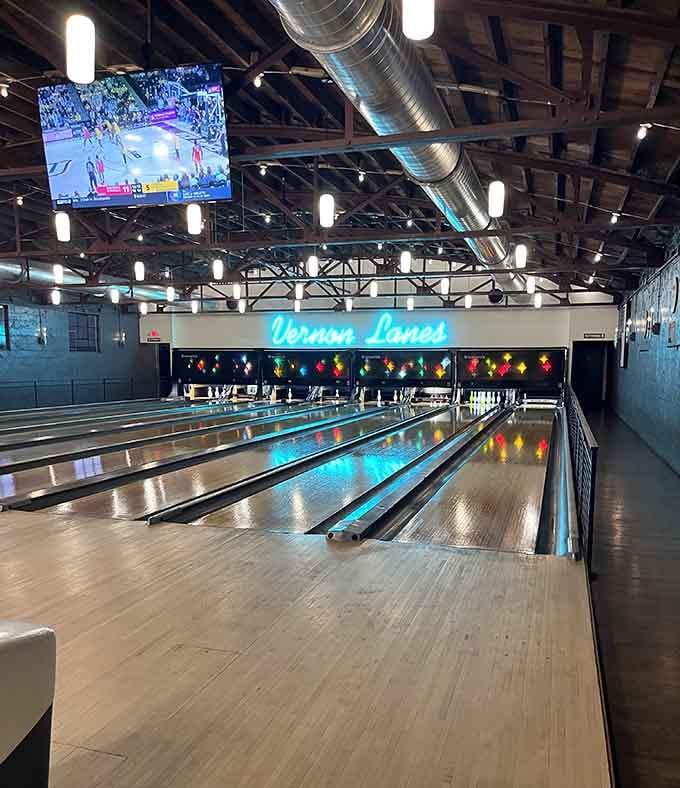 The view from lane level reveals industrial charm meeting mid-century magic in perfect bowling harmony.