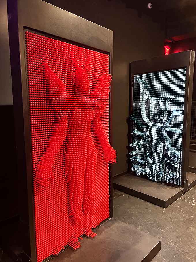 Thousands of pins capture your silhouette in 3D, creating temporary sculptures that disappear faster than your New Year's resolutions.