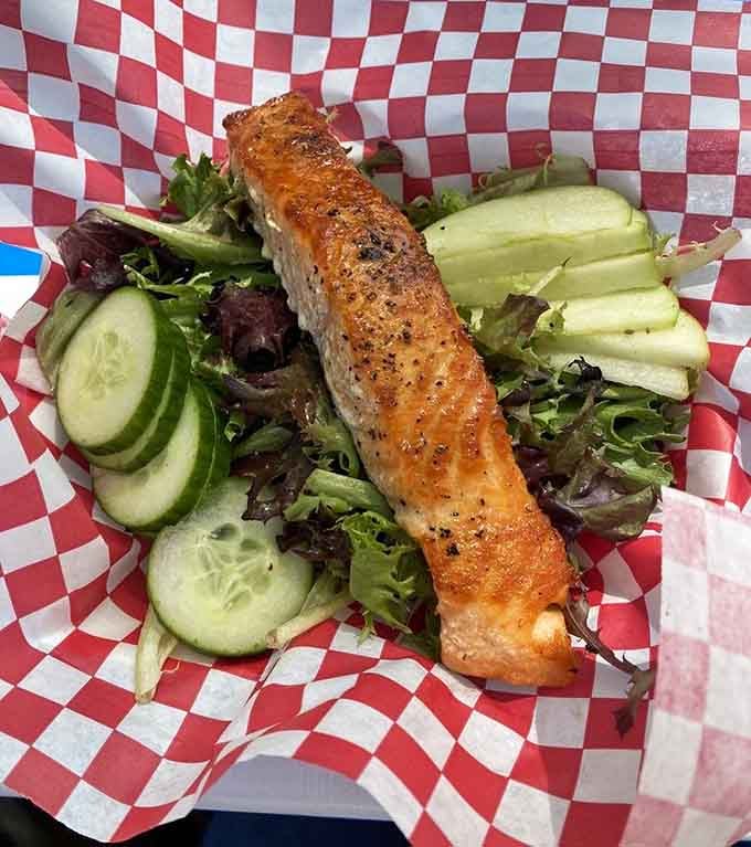 Perfectly seared salmon crowns fresh greens in a salad that makes healthy eating feel like a reward.