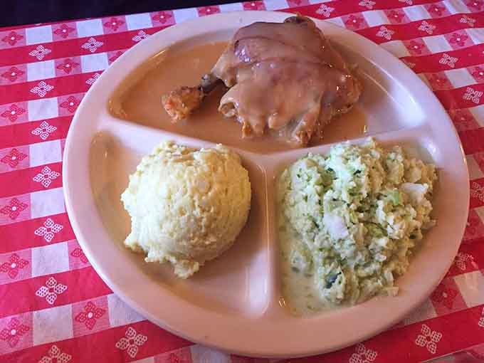 Baked chicken swimming in gravy with sides that understand their supporting role in this delicious production.