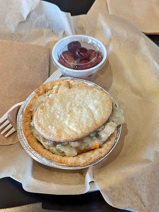 The chicken pot pie arrives like a personal hug, all flaky pastry and savory filling perfection.