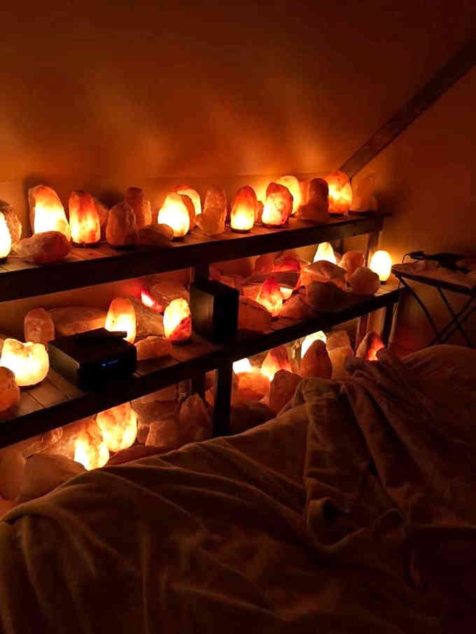 Rows of glowing Himalayan salt lamps line the shelves like a collection of warm, therapeutic nightlights for grownups.