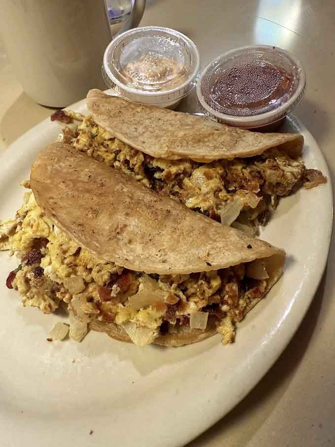 Breakfast tacos stuffed with scrambled eggs and sausage, because who says tacos are just for dinner anymore?