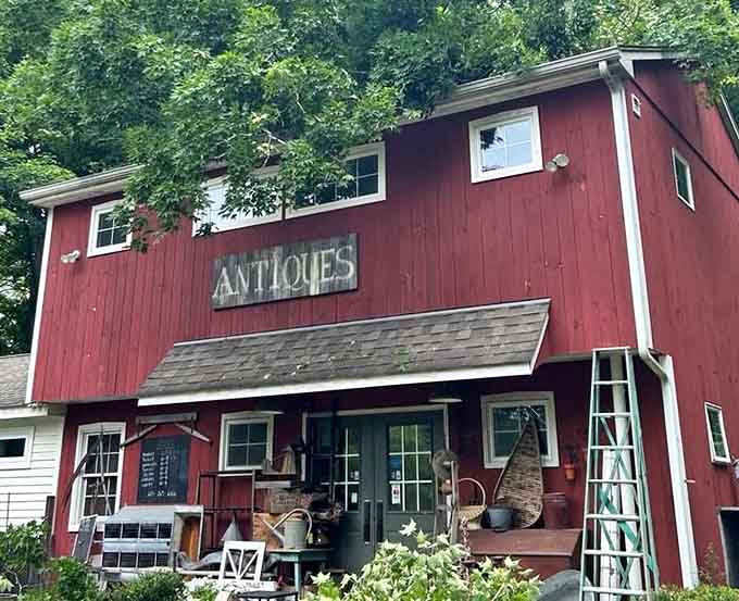 Big red barn screaming "antiques" louder than any billboard ever could, rustic charm meets serious treasure hunting.