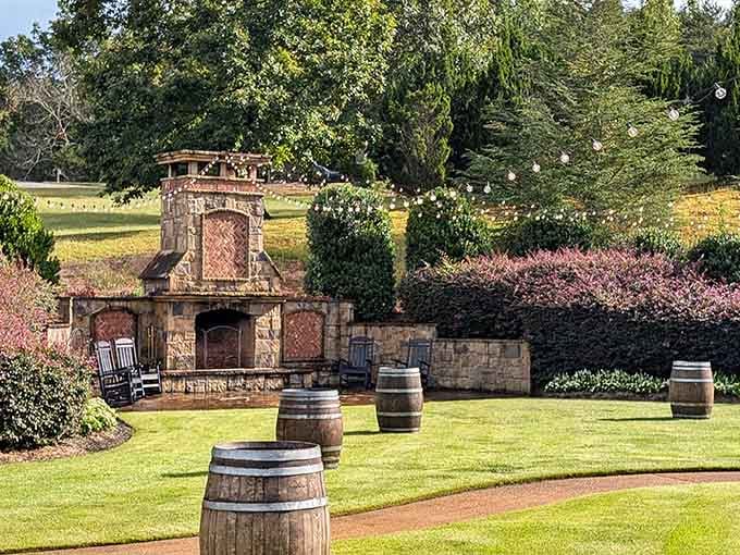 An outdoor stone fireplace flanked by wine barrels is basically the Georgia version of a Tuscan dream.