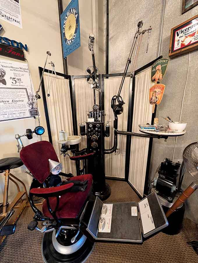 A vintage barber chair stands ready with its gleaming chrome arms, looking like something from a science fiction movie.