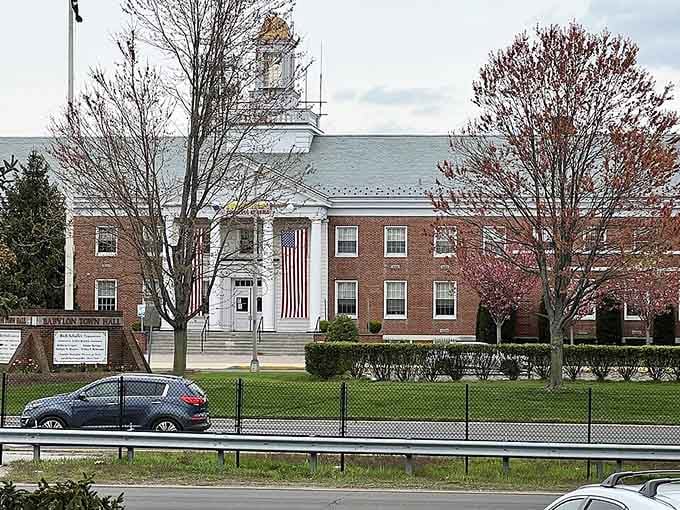 Classic brick and white columns frame this peaceful town center where spring blossoms hint at warmer days ahead.