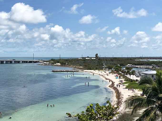 Those turquoise gradients and white sand rival any Caribbean postcard, with the historic bridge adding character and charm.