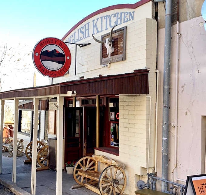 That wagon wheel and rustic porch give off serious frontier vibes that transport you to another era.