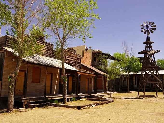 Weathered wooden storefronts and that tall windmill stand frozen in time under the bright Arizona sun at this ghost town.