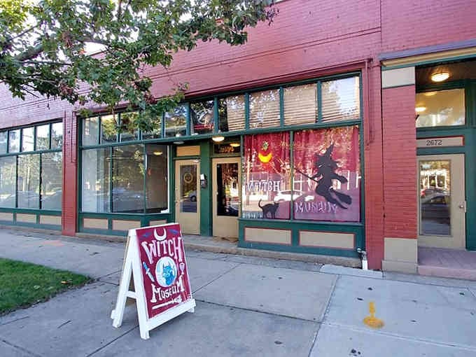 The storefront beckons with mystical promises, its bold signage and enchanting window displays drawing curious souls toward magical discoveries within.