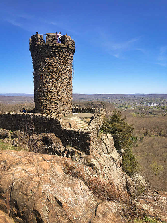 This weathered stone tower stands sentinel on the rocky summit, rewarding climbers with panoramic valley views.