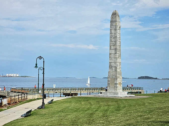 That slender monument points straight up beside the harbor, standing guard like a lighthouse made of stone instead of light.