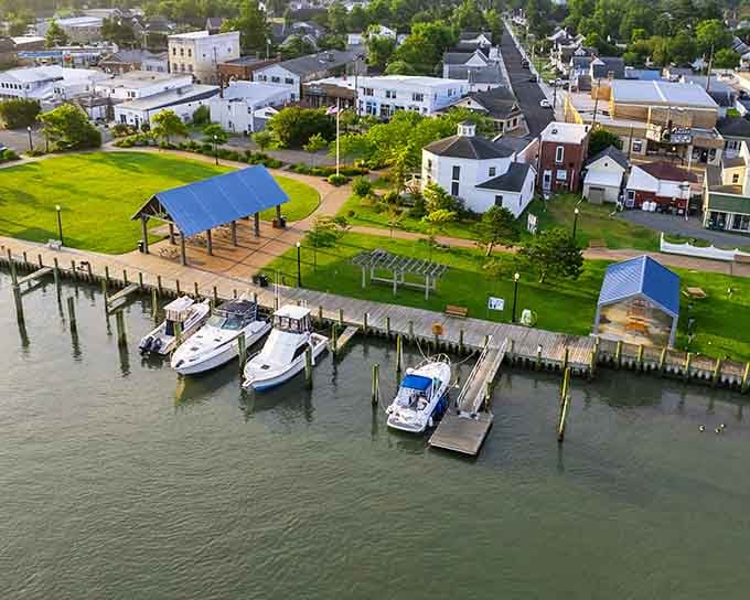 Boats bobbing at the dock while the town sleeps peacefully behind them, living the waterfront dream.