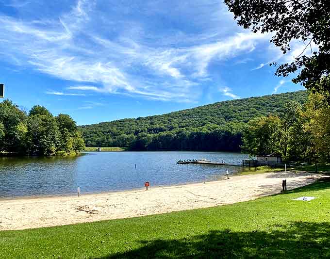 This sandy beach nestled against mountain waters offers the perfect summer escape without the ocean crowds.
