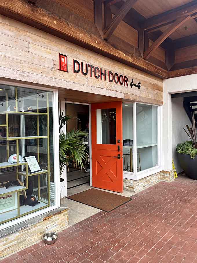 The bright orange Dutch door beckons visitors into Carmel's cozy spot for warm, made-to-order mini donut perfection.