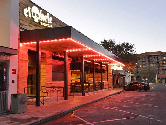 Red lights glow like a Vegas marquee, transforming this modern spot into a nighttime destination for tacos and fun.