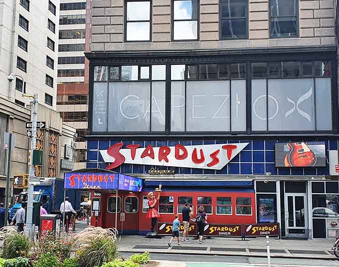 That retro neon glow in Times Square promises singing servers and classic comfort food with Broadway flair.