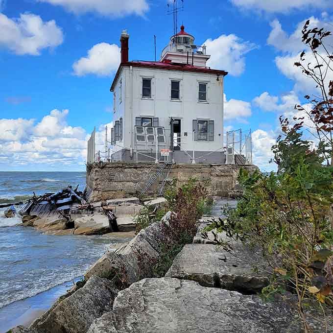 Perched dramatically on weathered rocks, this square lighthouse shows character earned through decades of lake storms.