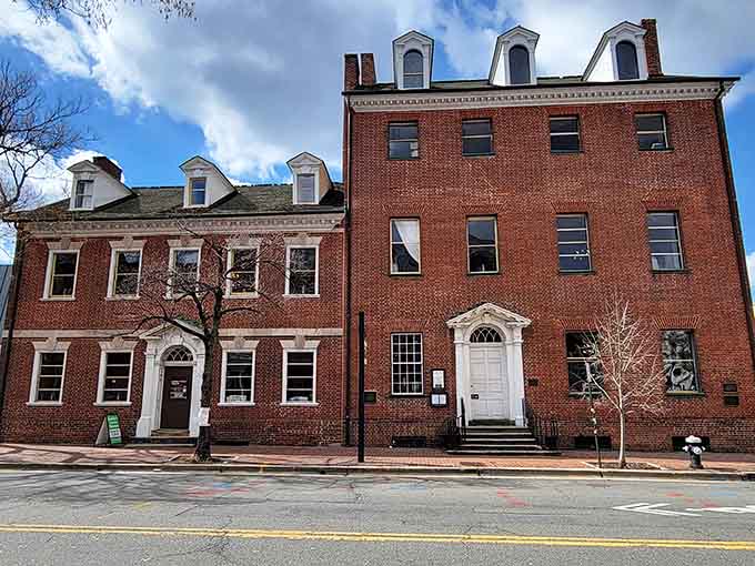 Classic colonial brick standing proud on a street corner where Washington himself might've grabbed a pint.