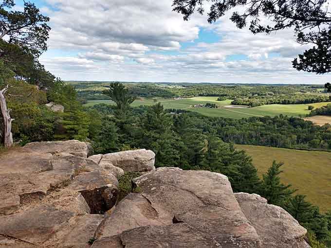 From this rocky perch, the patchwork farmland below spreads out like a quilt stitched by generations.
