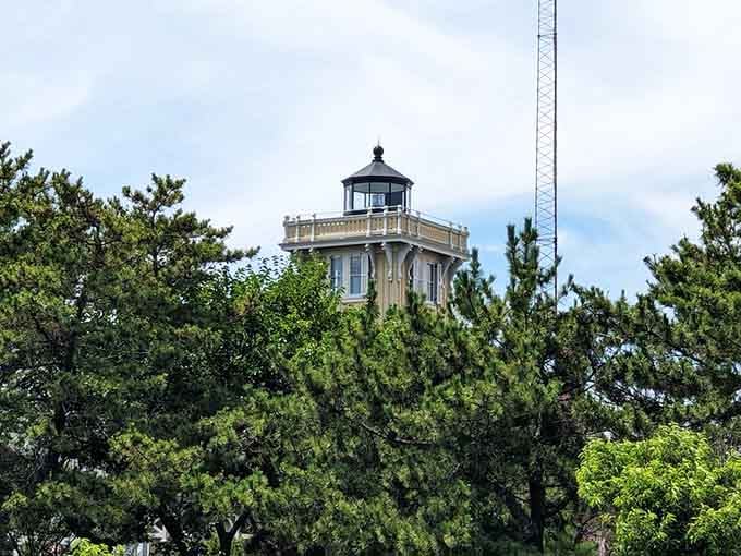 Peeking through the pines like a shy neighbor, this charming yellow tower proves lighthouses don't always need beaches.