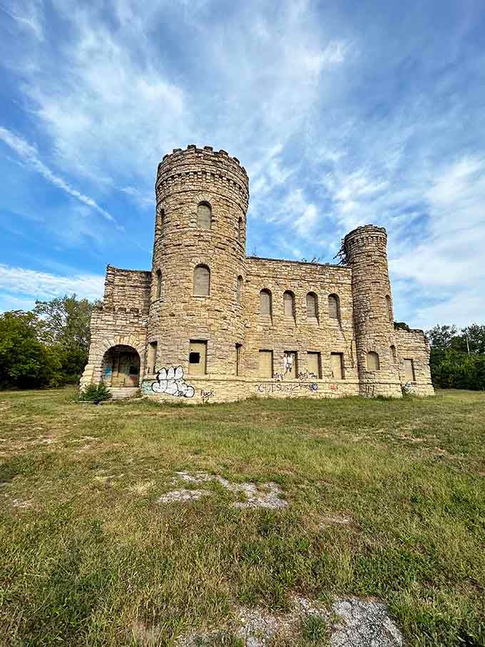 Twin towers frame the entrance like sentinels from another era, their weathered limestone speaking volumes about resilience and time.