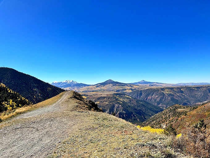 This winding mountain road cuts through golden aspens and evergreens, offering views that'll stop you every mile.