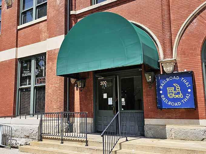 That elegant green awning marks the entrance to where Thai flavors meet Alabama railroad history in delicious harmony.