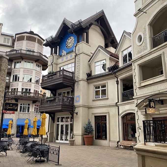 That blue clock tower rises above Alpine-style architecture that makes you wonder if you've somehow landed in Bavaria.
