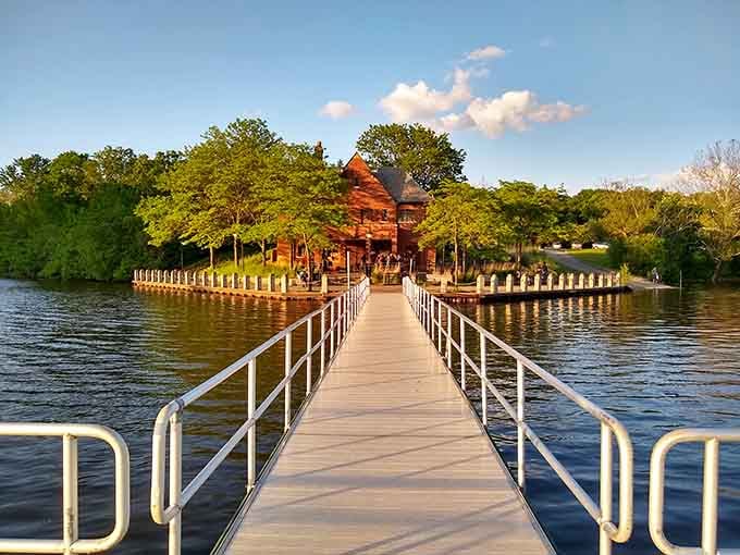 The historic boathouse sits like a rustic jewel on Livonia's lake, connected by a long pier perfect for sunset strolls.