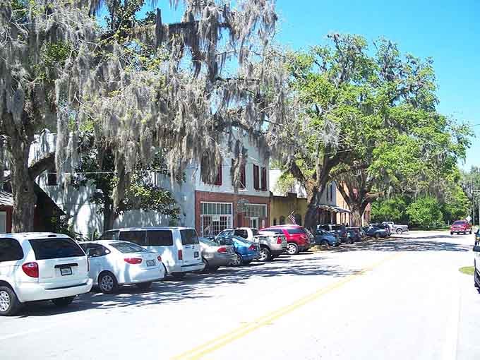 Spanish moss drapes like nature's curtains over a main street that time forgot to update—thankfully.