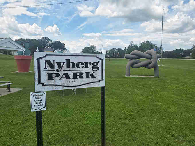 The park sign promises quirky metal sculptures that transform ordinary farm tools into extraordinary works of prairie art.