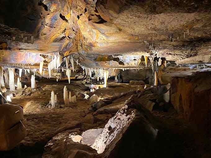 Underground chambers glow with otherworldly beauty as stalactites hang like chandeliers in earth's hidden ballroom.