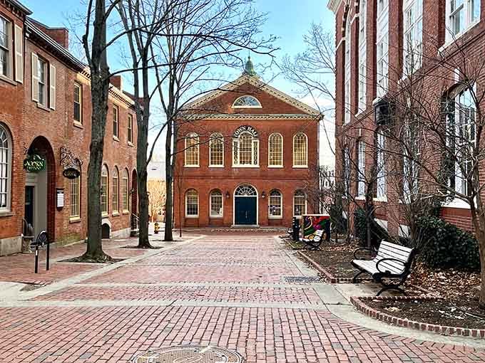 Federal-style brick and white trim stand proudly in the square, looking exactly like a history textbook illustration come alive.