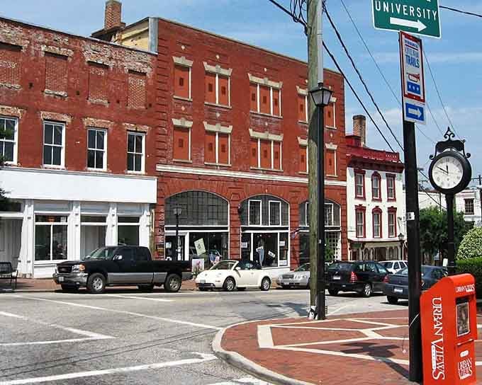 Classic brick architecture and a street clock show that some towns still measure time in conversations, not clicks.