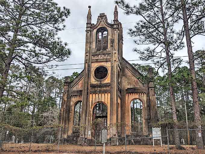 Gothic spires reach skyward through the pines, their empty windows watching over a congregation that exists only in memory.